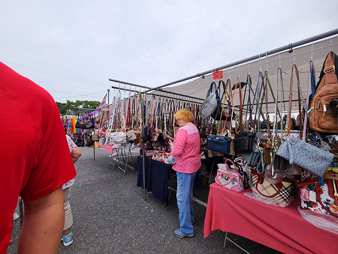 Handbag heaven where fashion meets function. That woman in pink is strategizing which purse will best hold her farmers market treasures and future impulse buys.
