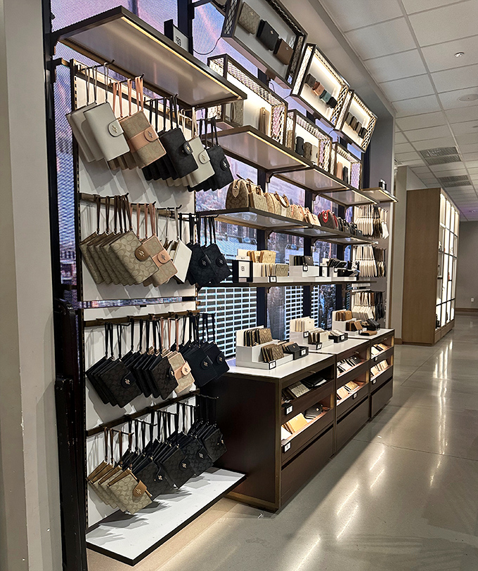 Coach's handbag display &ndash; where leather dreams are arranged with military precision and your credit card starts to sweat.