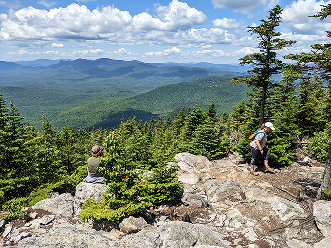 Summit seekers are rewarded with this breathtaking panorama&mdash;Maine's mountains rolling away like waves frozen in time, worth every step of the climb.