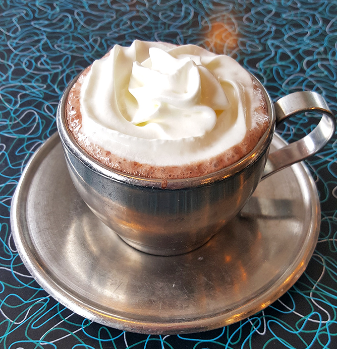 Hot cocoa elevated to an art form, with whipped cream so perfect it deserves its own Instagram account.
