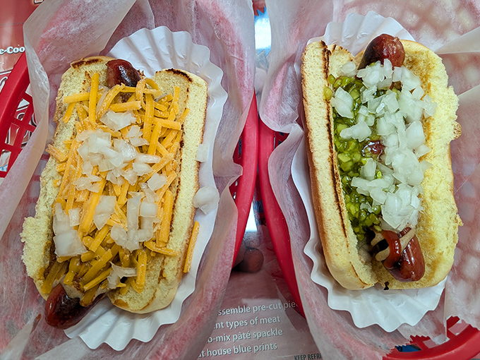 A study in contrasts: golden toasted buns cradle perfectly charred dogs topped with vibrant toppings. This is hot dog architecture at its finest.