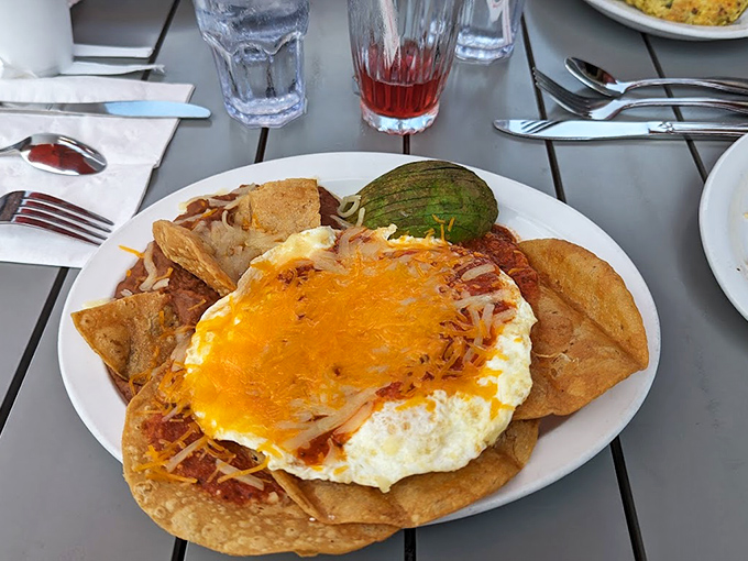 Huevos Rancheros: where breakfast meets fiesta. That avocado slice is the green light giving you permission to dive in.