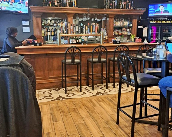 The bar area strikes that perfect balance between "fancy enough for a date" and "comfortable enough to watch the game." Wood tones warm the space like a hug.