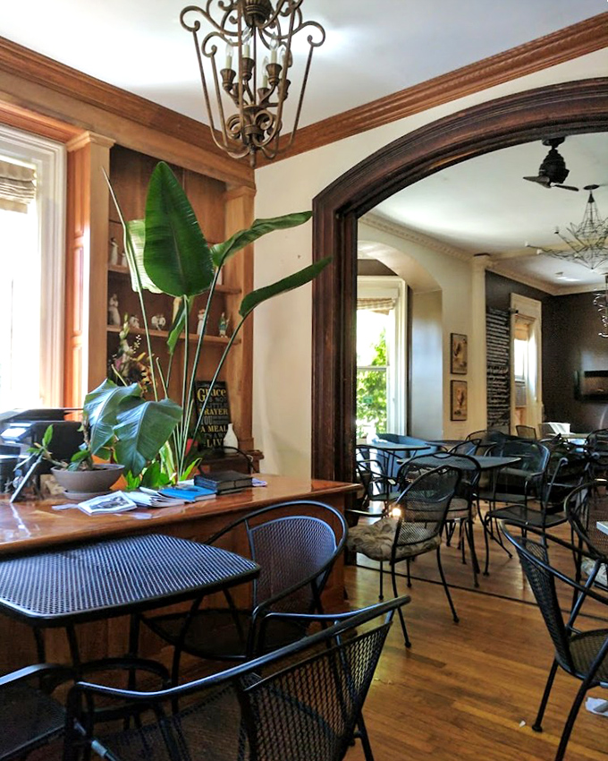 Where elegant archways frame casual conversations. Potted palms and wooden accents create a space that's both timeless and inviting.