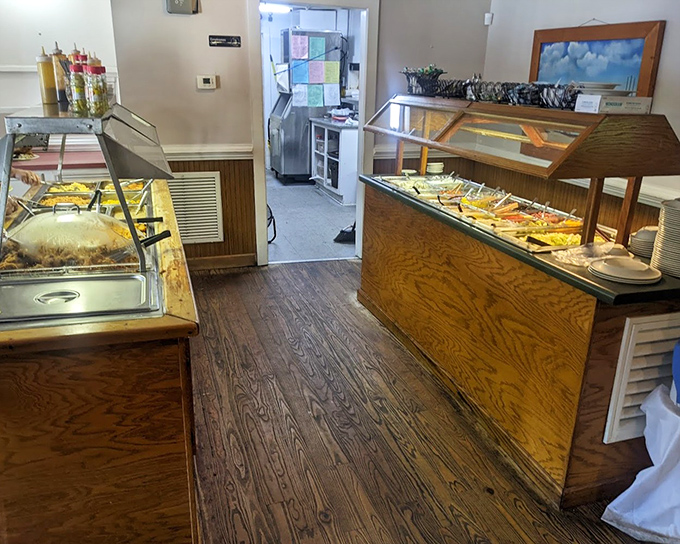 The salad bar stations stand ready to provide vegetables for anyone still pretending they came here for health reasons.