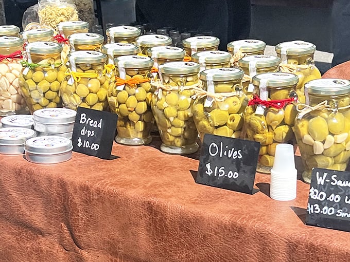 Olives basking in golden oil like tiny sunbathers, each jar a Mediterranean vacation waiting to happen in your Great Falls kitchen.