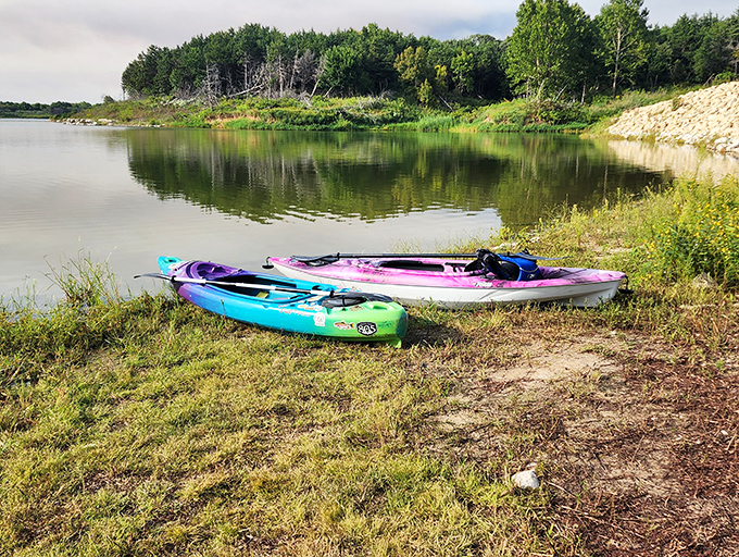 Kayaks waiting patiently for their next adventure. These colorful vessels are your tickets to discovering hidden coves and peaceful shorelines.