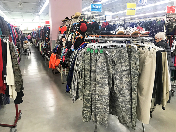 The treasure hunt begins! Military fatigues hang alongside everyday jackets, while a shopper in the distance carefully examines what might be their next great find.