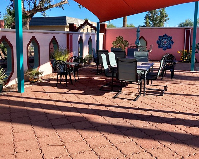 Outdoor seating under a desert-red canopy &ndash; where the shade is as welcome as the peaceful atmosphere.