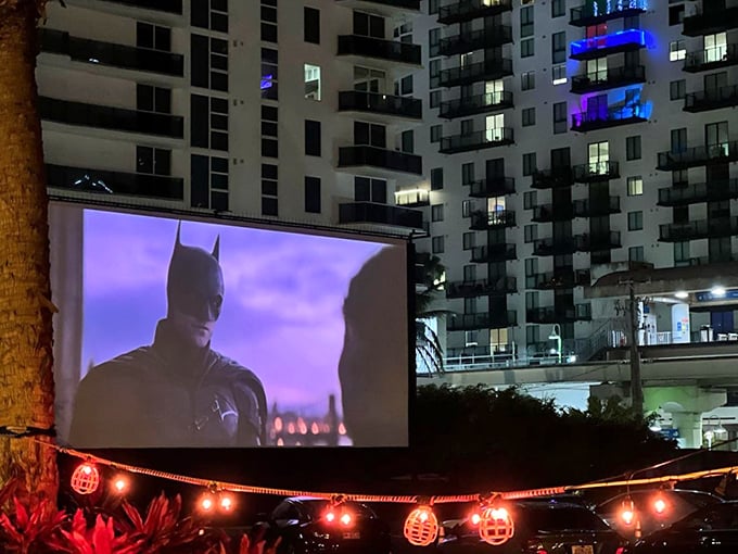 Batman watches over Miami tonight, with string lights adding a carnival atmosphere to this unconventional urban theater experience.