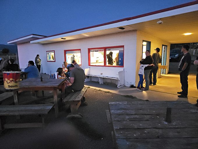 The social heart of the Basin Drive-In, where strangers become friends over shared anticipation and picnic table conversations.