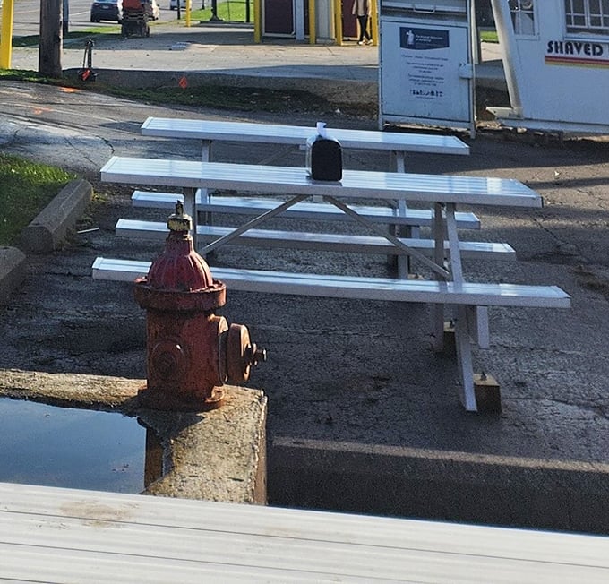 The white picnic tables outside aren't just seating&mdash;they're community gathering spots where strangers become friends over shared food experiences.