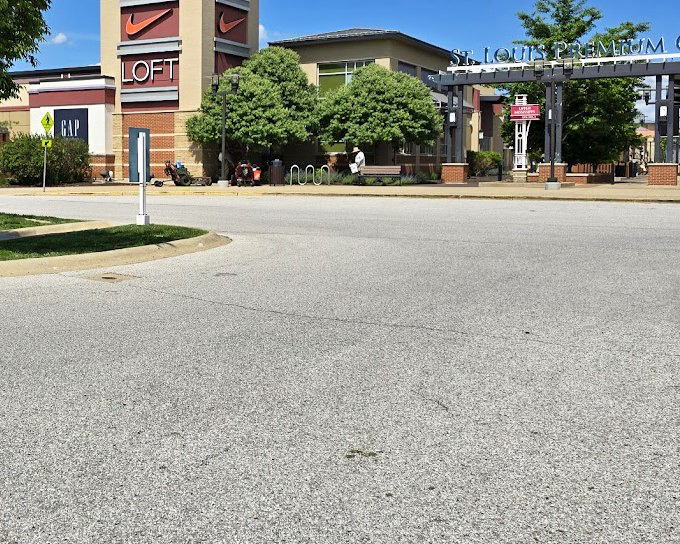 The entrance beckons like retail's pearly gates. That LOFT and Nike combination is practically whispering, "Your wallet had a good run."