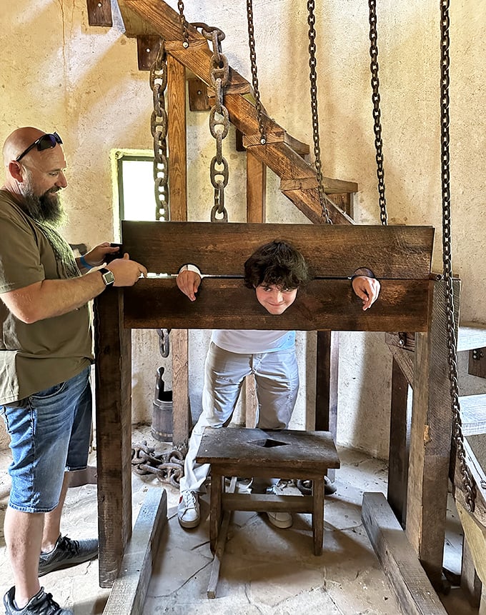Interactive wooden stocks let visitors experience medieval justice firsthand, creating memorable photo opportunities and laughs.