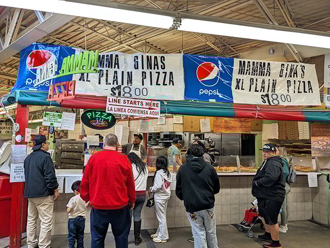 Mama Gina's pizza counter draws crowds with massive pies that promise to feed the family and then some.