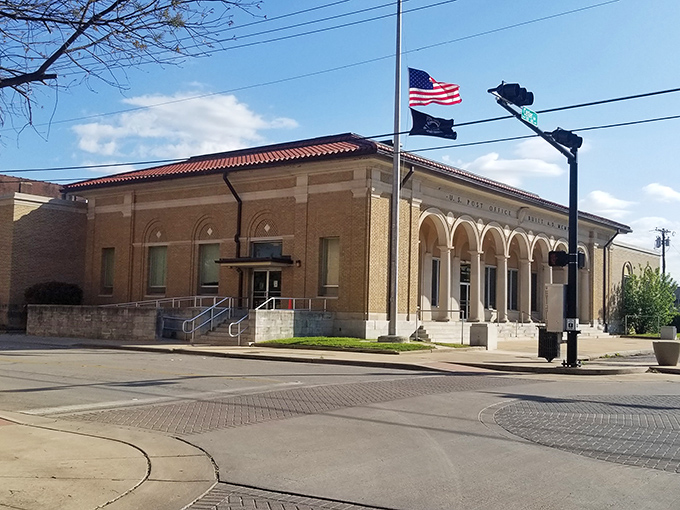 The Post Office stands proud with its arched entryway, a daily gathering spot where small-town news travels faster than any text message.