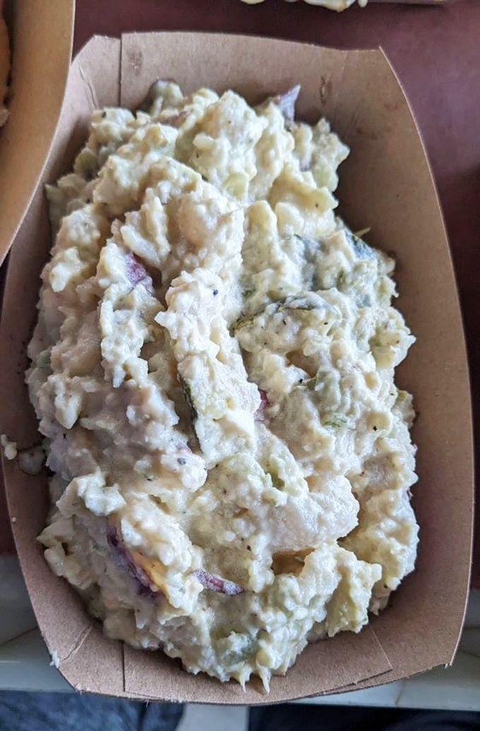 Potato salad that doesn't know it's a side dish. Creamy, chunky, and assertive enough to hold its own against the smokehouse heavyweights on your tray.