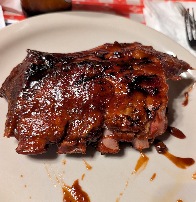 Barbecue ribs so tender, they practically leap off the bone and into your heart. The sauce-to-meat ratio? Mathematical perfection.