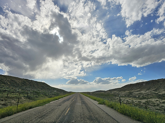 The road less traveled often leads to the best discoveries. This stretch of Wyoming asphalt promises adventure under impossibly big skies.