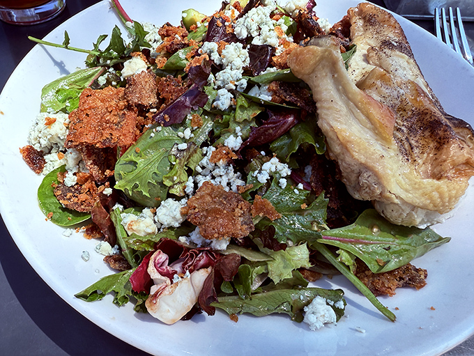 Not just a salad, but a masterpiece of textures where crisp greens meet crunchy toppings and a perfectly cooked protein for good measure.