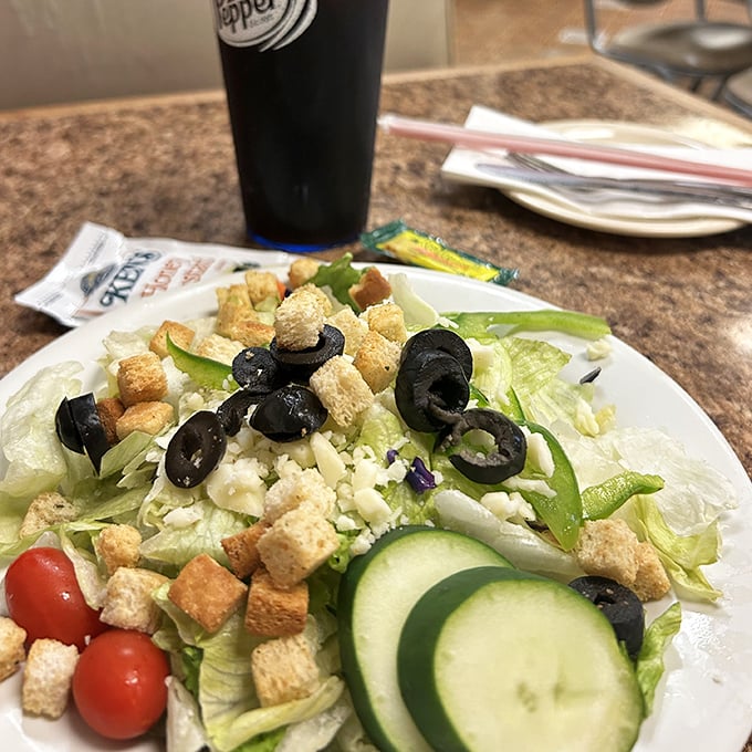 Even the salad looks like it's having a good time, with olives and croutons mingling like old friends at a reunion.