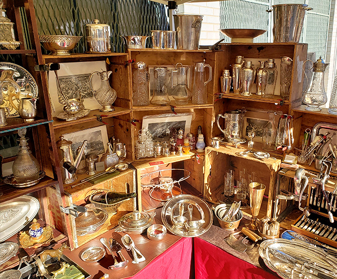 Silver treasures gleam from wooden shelves, each piece holding memories of elegant dinner parties and Sunday roasts from another era.