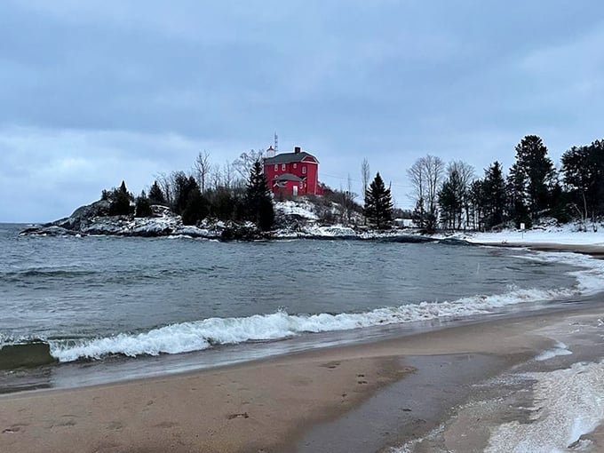 Winter transforms McCarty's Cove into a snow-kissed wonderland. The lighthouse stands defiant against Michigan's elements&mdash;a splash of warmth in the winter palette. 