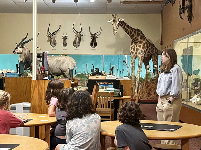 Knowledge transfer in action! A museum educator brings the African savanna to life for captivated young minds.