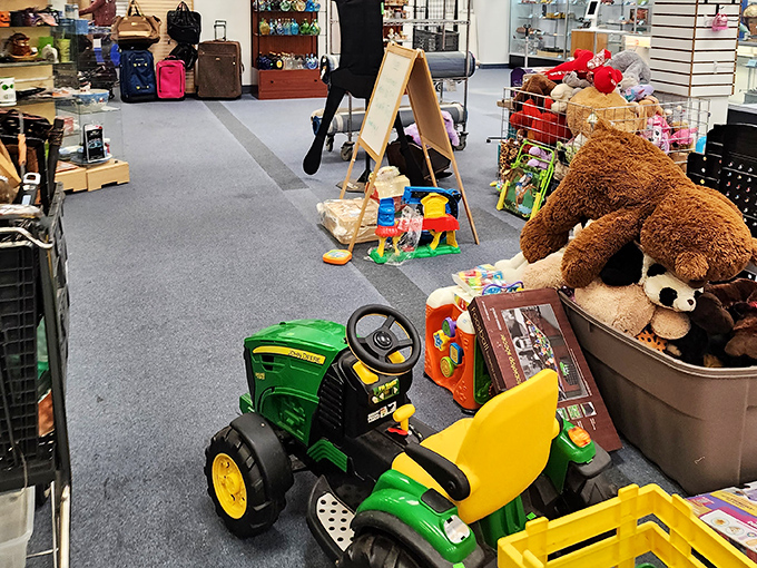 Kids' toys wait patiently for their next adventure, from ride-on tractors to stuffed friends needing new homes.