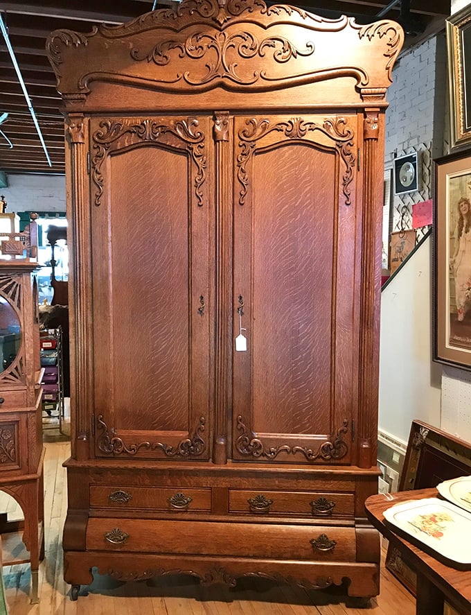 This ornate cabinet stands like a wooden cathedral, waiting to bless someone's dining room with its presence.