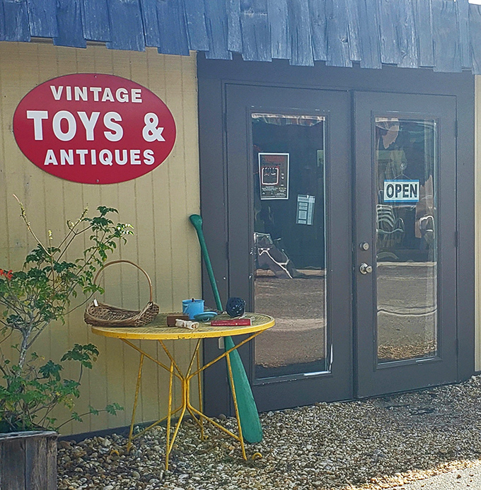 The "Vintage Toys & Antiques" sign promises a nostalgia trip inside. That yellow bistro table is practically begging to come home with you.