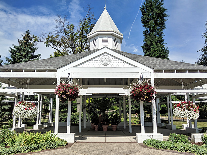 Wedding bells practically ring themselves in this picture-perfect gazebo. Hanging baskets overflow with blooms that seem to defy gravity.