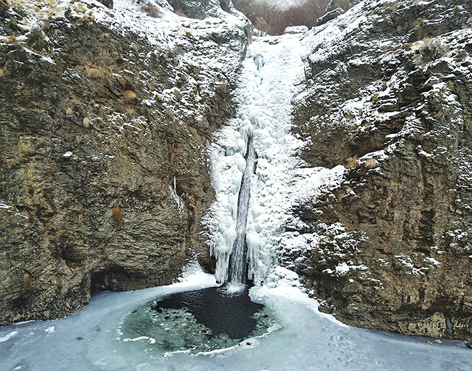 Winter transforms the falls into a frozen fantasy, with ice sculptures replacing summer's flowing cascade in this seasonal magic show.
