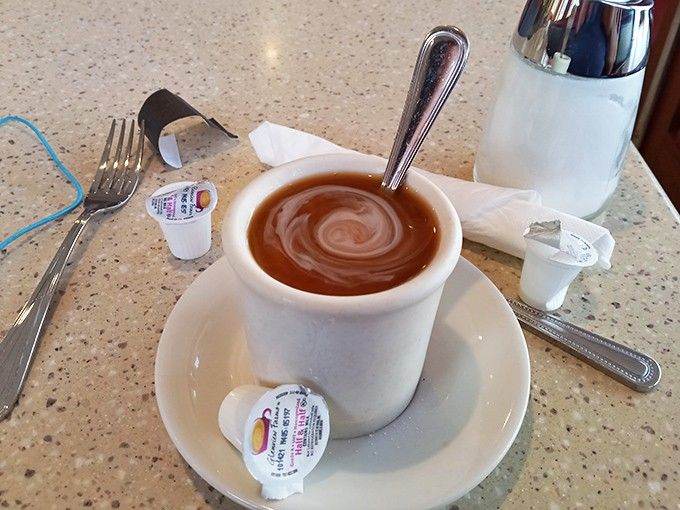 Hot coffee swirling in a classic diner cup, ready to fuel your morning with liquid motivation and warmth.