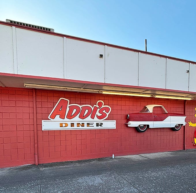 Addi's classic car emblem on brick-red walls &ndash; a hint that this diner takes you on a delicious ride to simpler times.