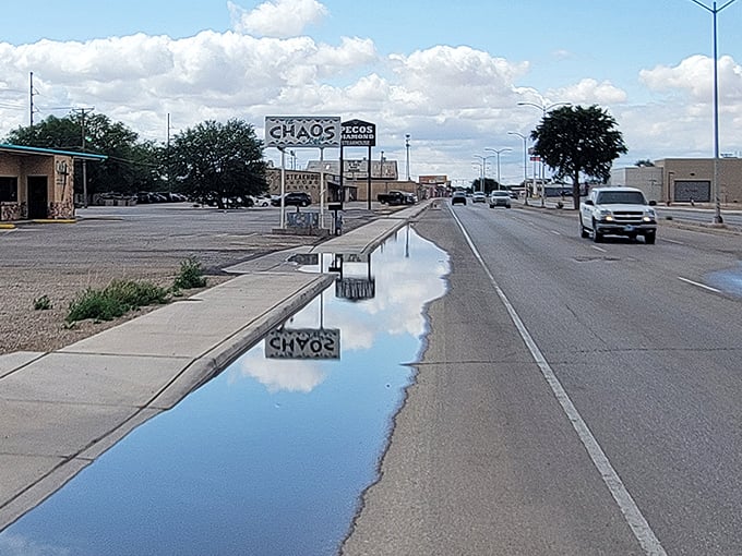 The "CHAOS" sign perfectly captures small-town charm &ndash; where even puddles slow down to reflect on life's simple pleasures.