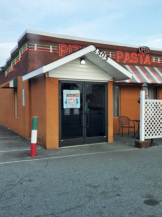 The classic red awning and traditional facade promise old-school pizza craftsmanship at its finest.