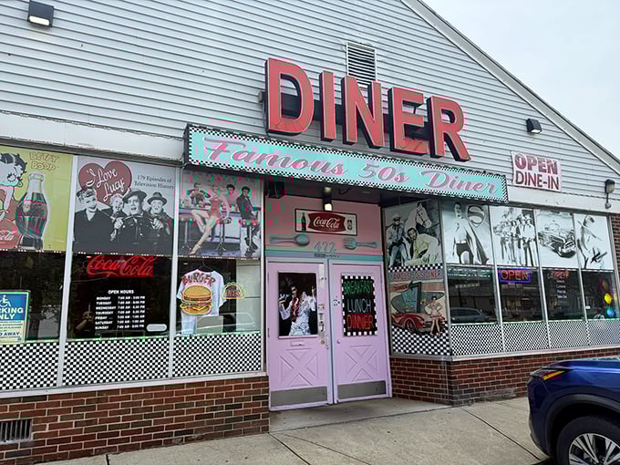 Famous 50's Diner wears its nostalgia proudly with vintage photos and that perfect pink door. The checkerboard trim completes the time-travel experience before you even step inside.