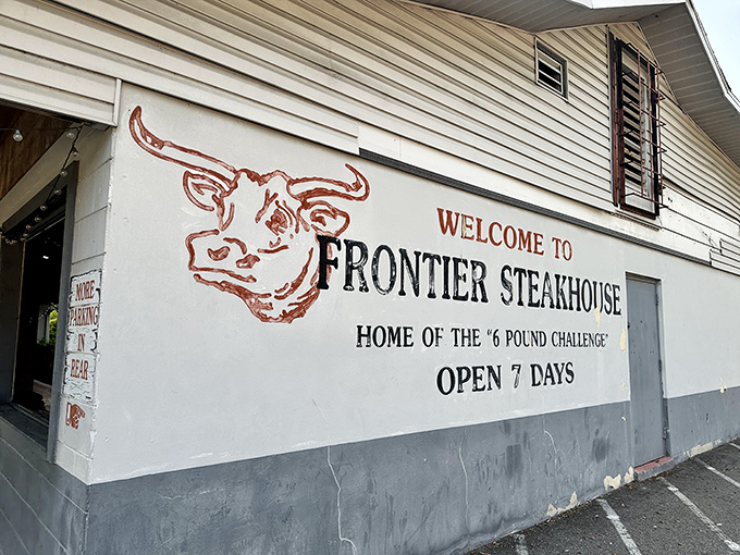 That hand-painted bull on Frontier's wall has been watching satisfied customers waddle out for decades.