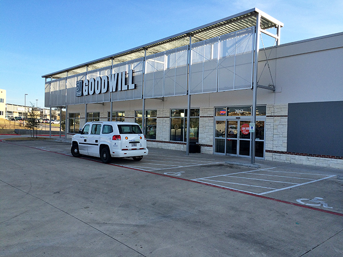 Goodwill's modern glass facade gleams like a beacon for bargain hunters seeking retail redemption.