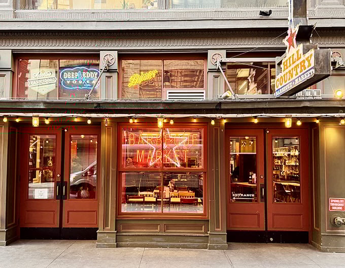 Twinkling lights and neon nights! Hill Country's rustic wooden entrance transports Manhattan diners to Texas pastures where brisket is king and sauce is optional.