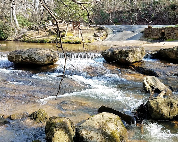 The South Fork River creates gentle rapids beneath Watson Mill Bridge. Smooth rocks and flowing water form nature's own meditation space.