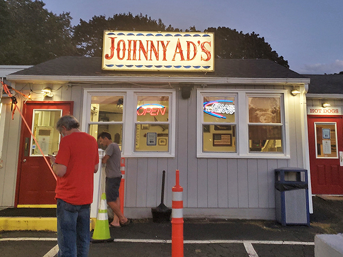 Johnny Ad's iconic roadside sign glows like a lighthouse for seafood lovers, beckoning hungry travelers with promises of no-frills deliciousness.