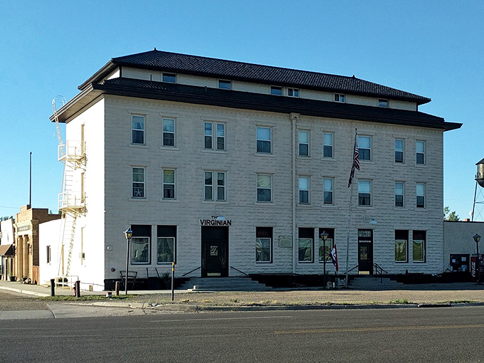 The majestic Virginian Hotel dominates Medicine Bow's skyline like a limestone lighthouse guiding travelers through Wyoming's prairie sea.