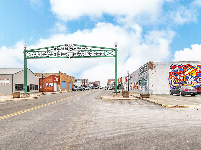 The emerald green "MIAMI OK" arch stands like a welcoming hug over Main Street, where Route 66 nostalgia meets small-town Oklahoma charm.