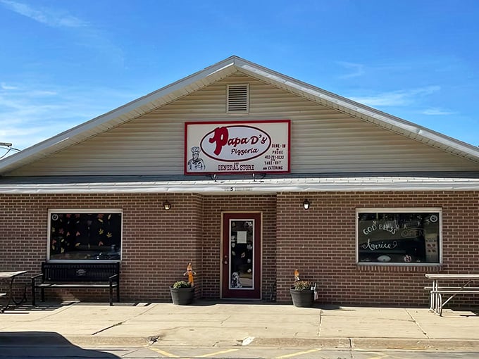 Papa D's welcoming storefront beckons like an old friend. That red sign promises pizza magic in this charming Firth landmark.