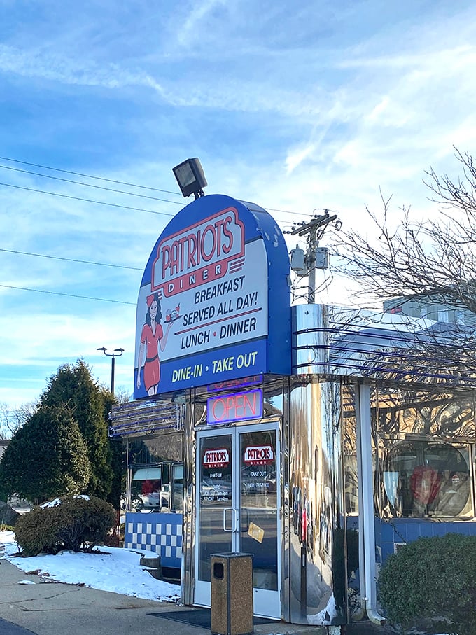 Patriots Diner's distinctive sign features a waitress ready to serve. This blue-trimmed beacon promises all-American comfort in Woonsocket.