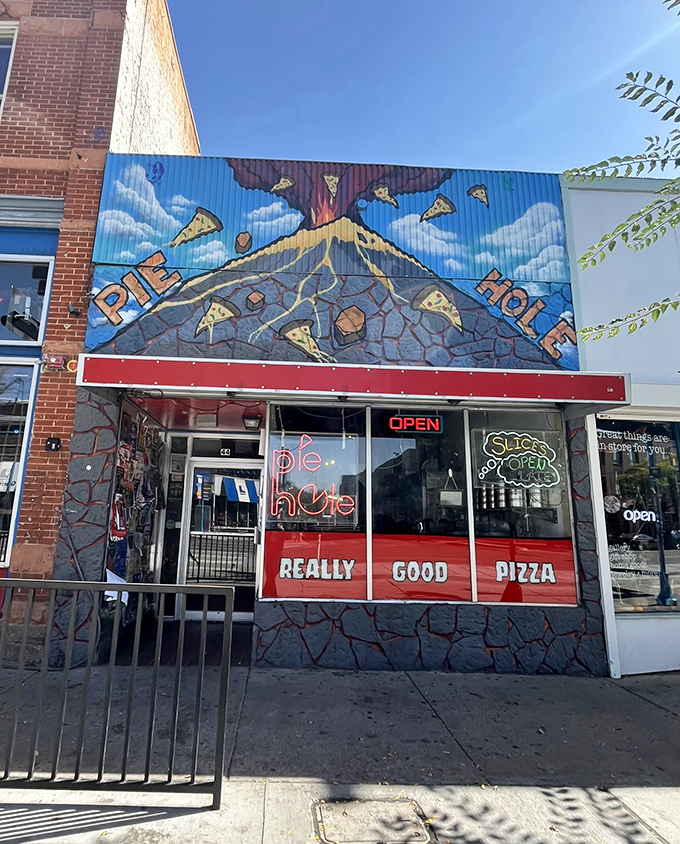 Pie Hole's volcanic eruption mural makes a bold statement: pizza excitement lies within! That "REALLY GOOD PIZZA" window sign isn't lying.