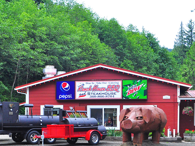 A red cabin in the woods with a pig statue standing guard &ndash; Ranch House BBQ knows exactly what priorities matter!