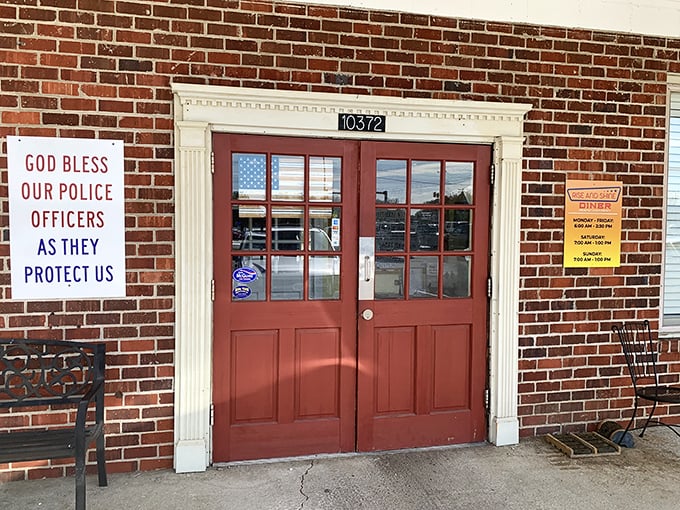 The simple brick exterior and patriotic message remind you that some places still believe in serving community, not just customers.